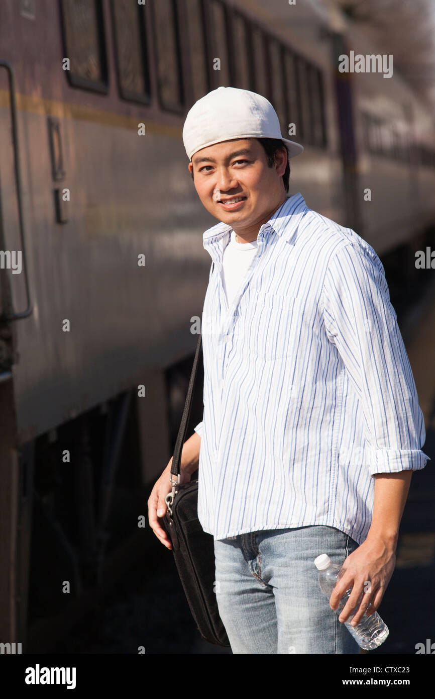 Chinese student standing near a commuter train Stock Photo - Alamy