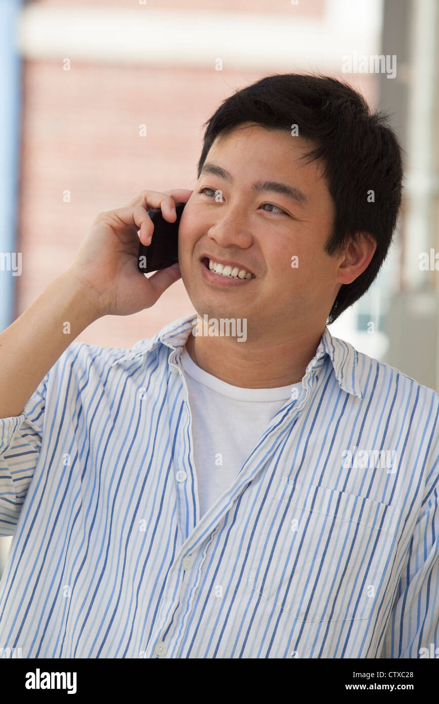 Chinese man talking on his cell phone Stock Photo - Alamy