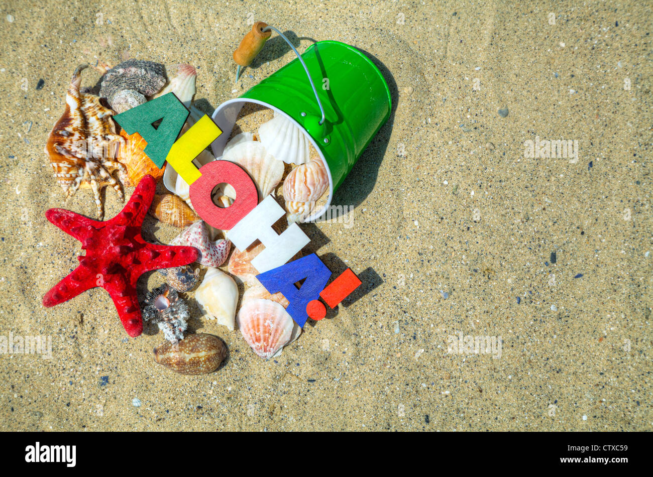 Wooden colorful word 'Aloha' with shells on the sand Stock Photo - Alamy