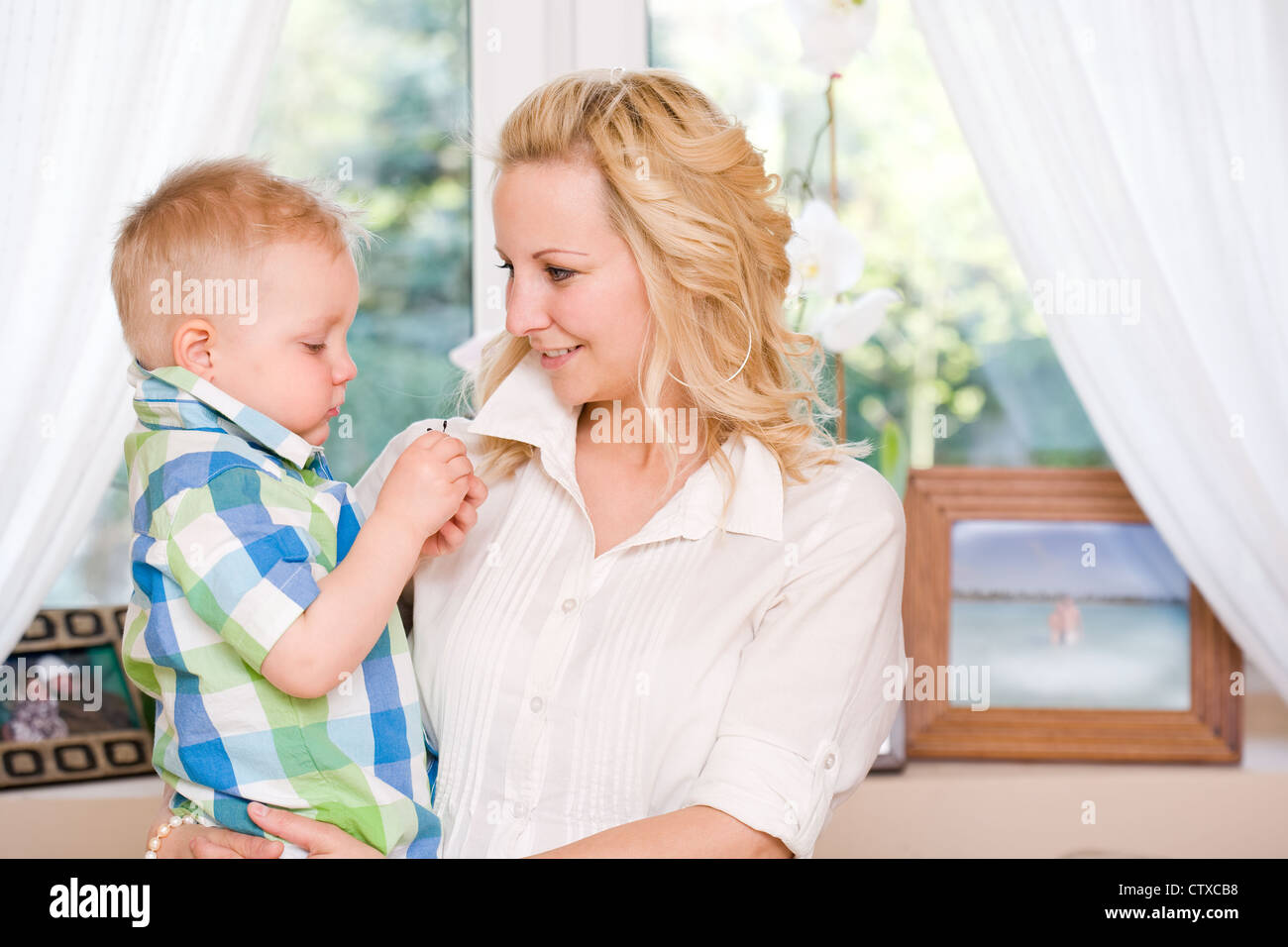 Indoors portrait of a very happy mom and son together Stock Photo - Alamy