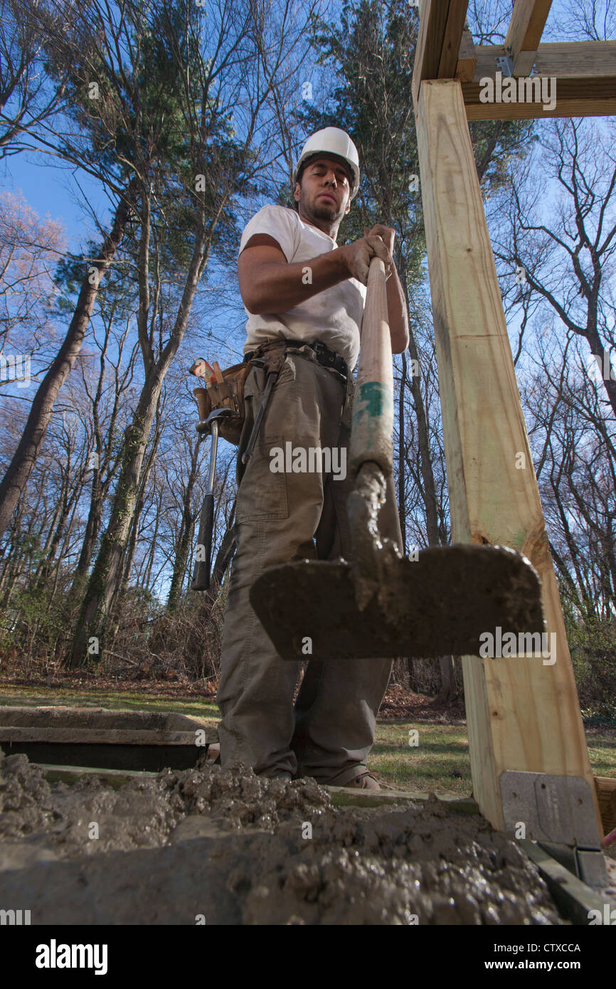 Hispanic carpenter leveling concrete in staircase footing Stock Photo ...