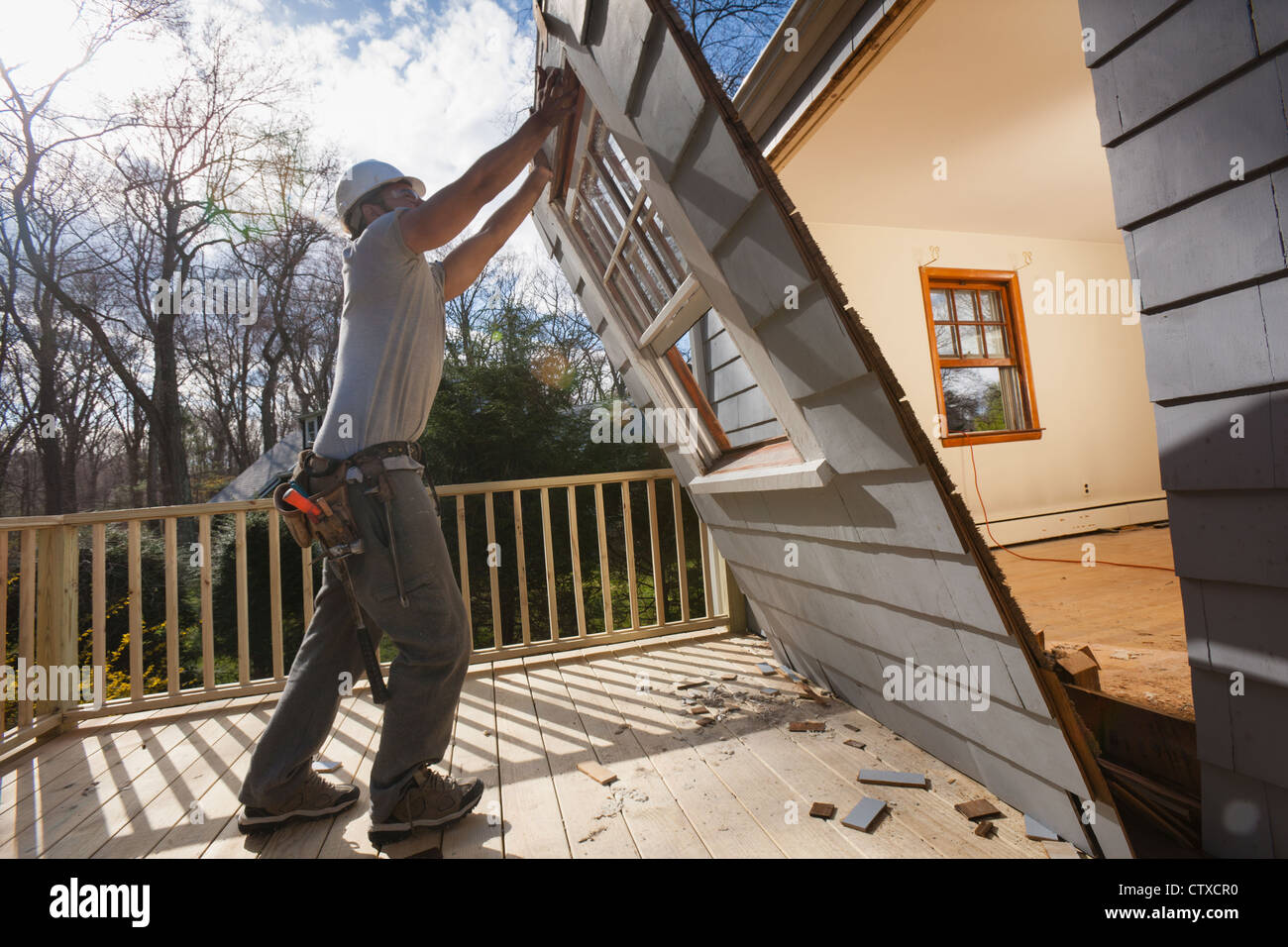 Hispanic carpenter removing newly cut door access to deck on home Stock ...