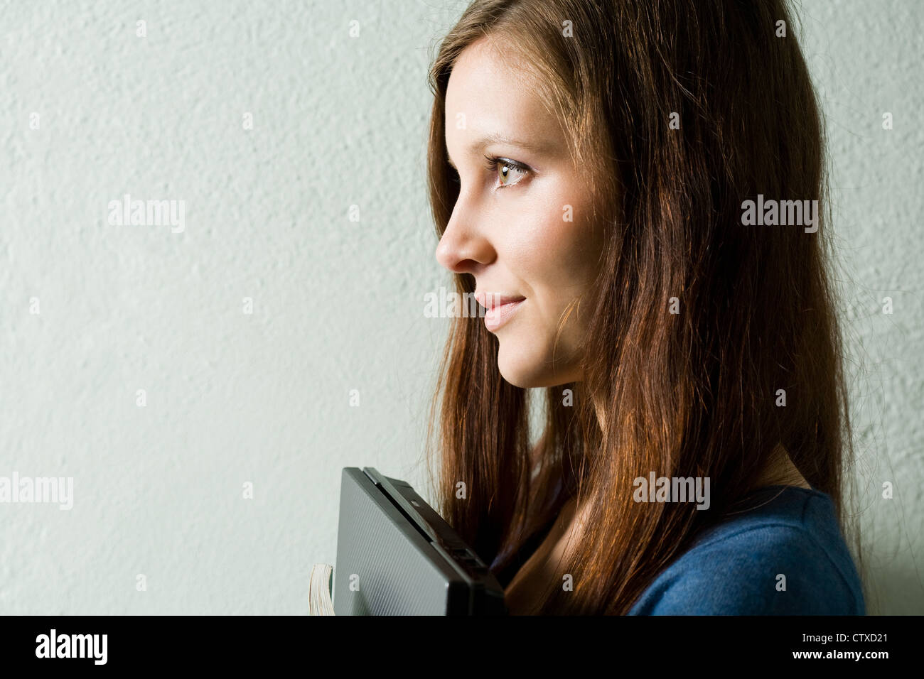 Looking forward, closeup profile portrait of a brunette student girl ...