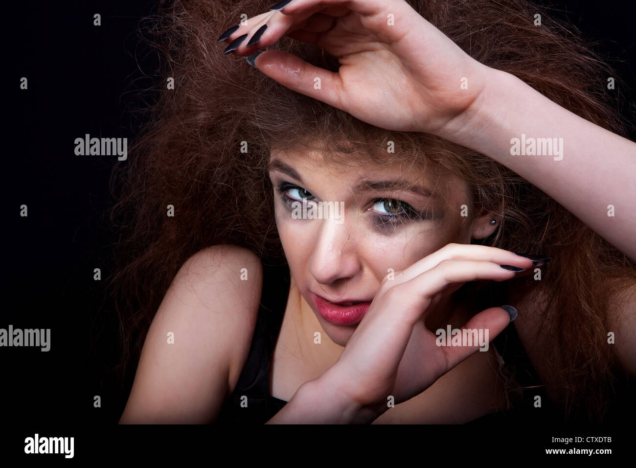 Frightened teenage girl covering her face against someone Stock Photo ...