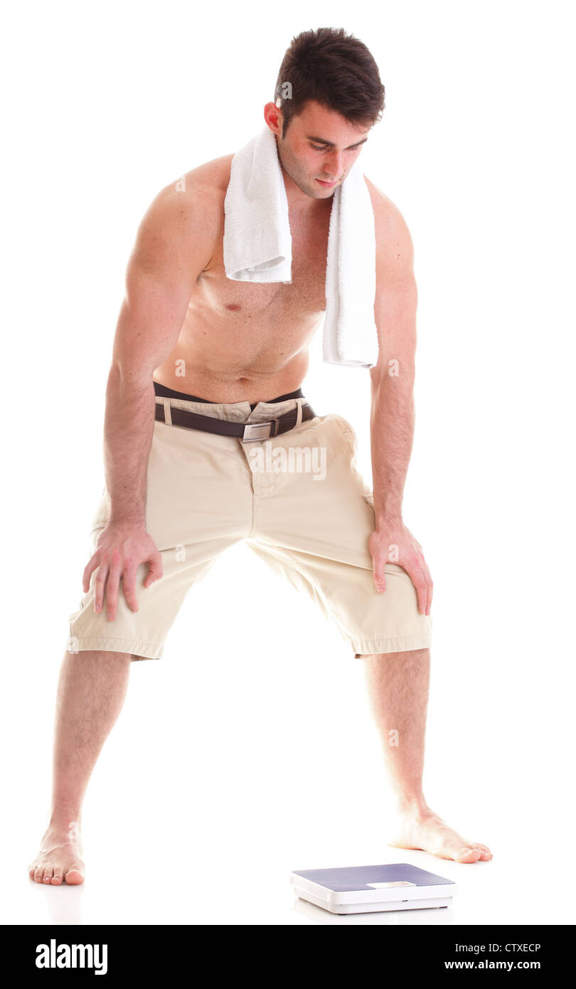 Healthy young man with a weight scale. Isolated over white background ...