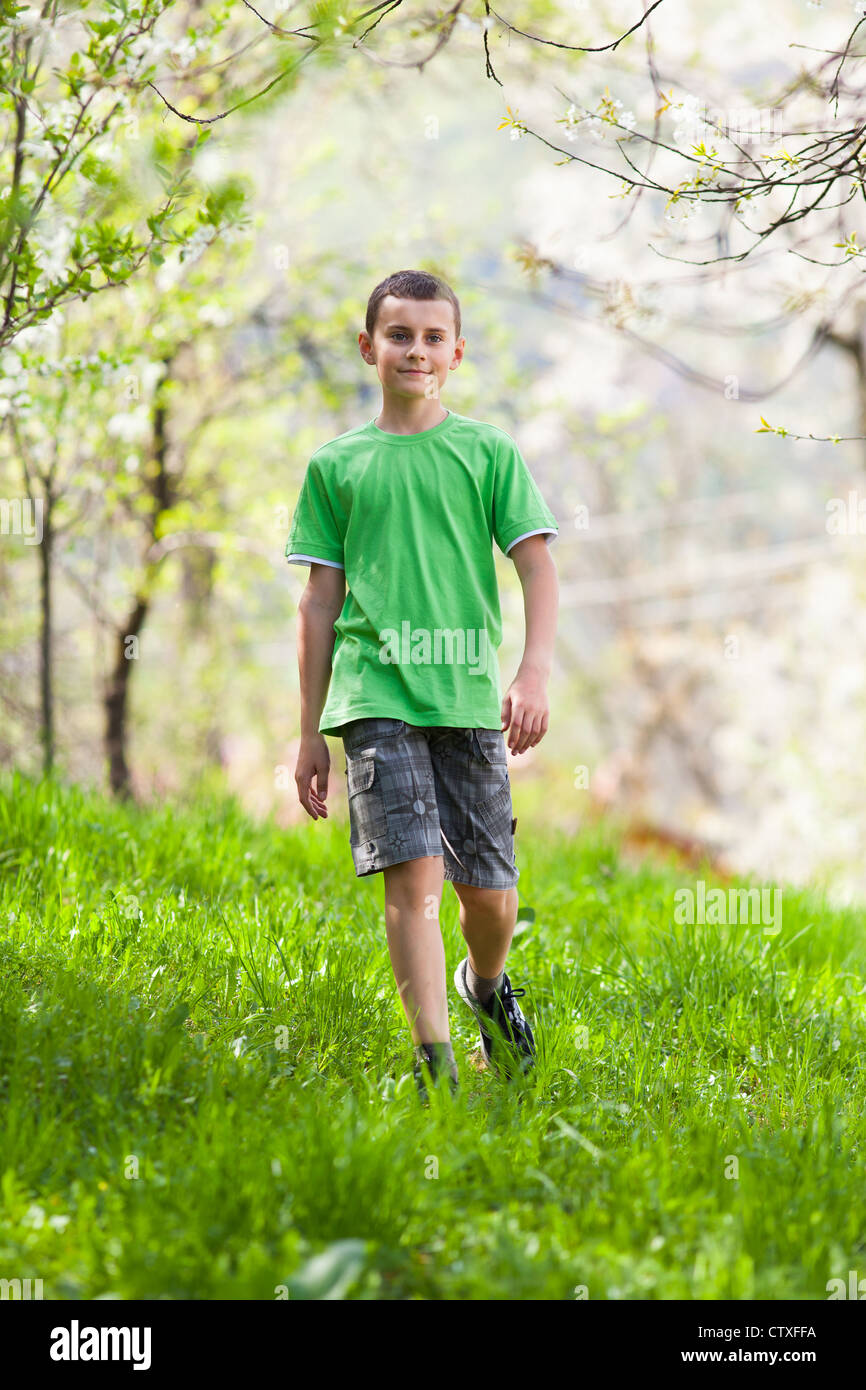Full length portrait of a boy walking outdoor in a forest Stock Photo ...