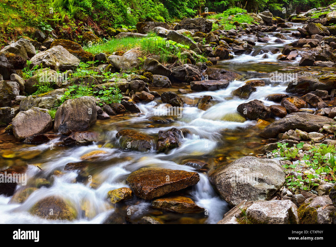 Landscape with river flowing through rocks Stock Photo - Alamy