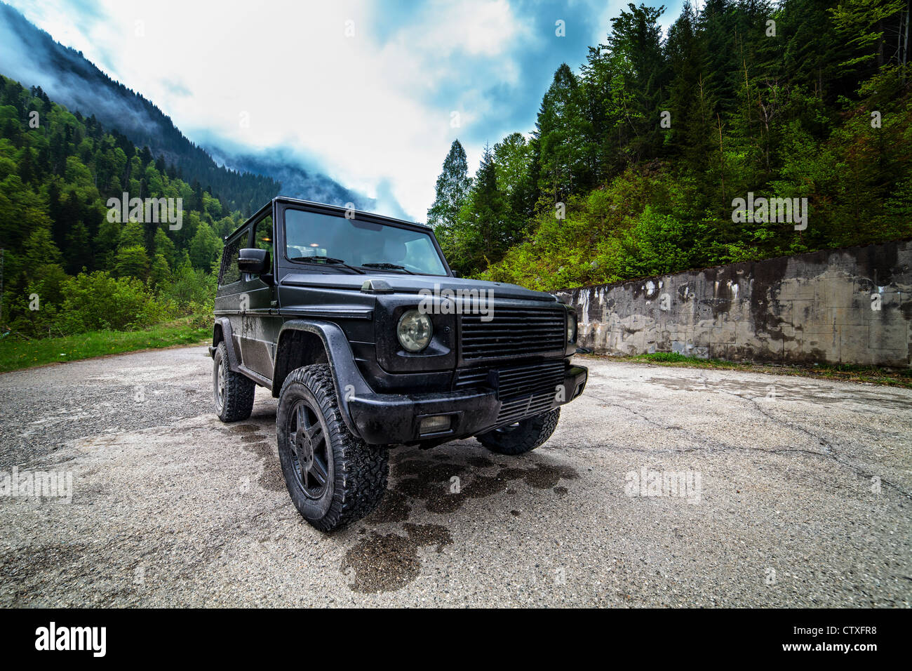 Rugged off-road car in the mountains Stock Photo - Alamy