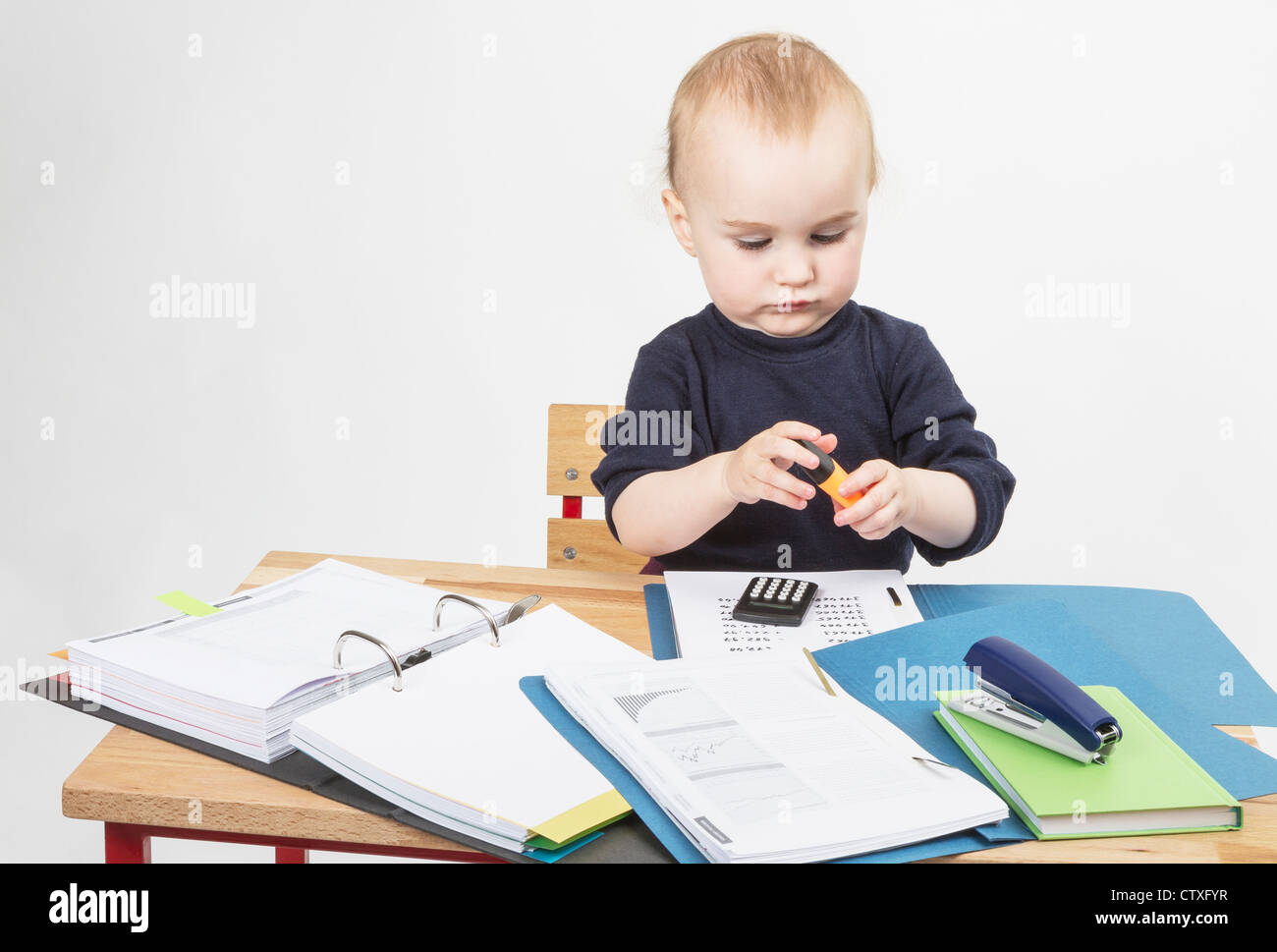young child working at writing desk in light background Stock Photo - Alamy