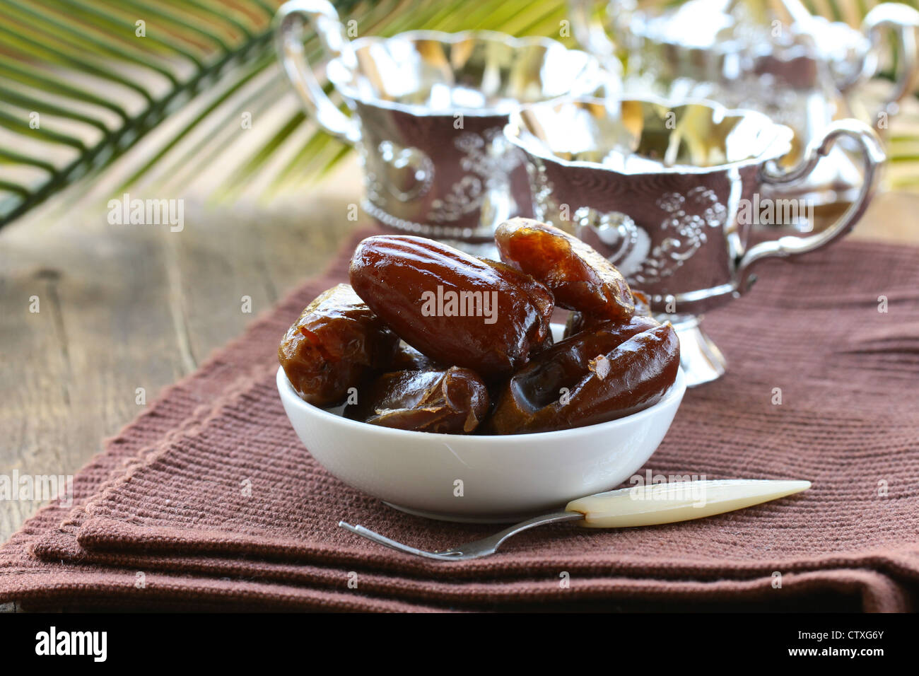 sweet dates in bowl on a natural background Stock Photo - Alamy