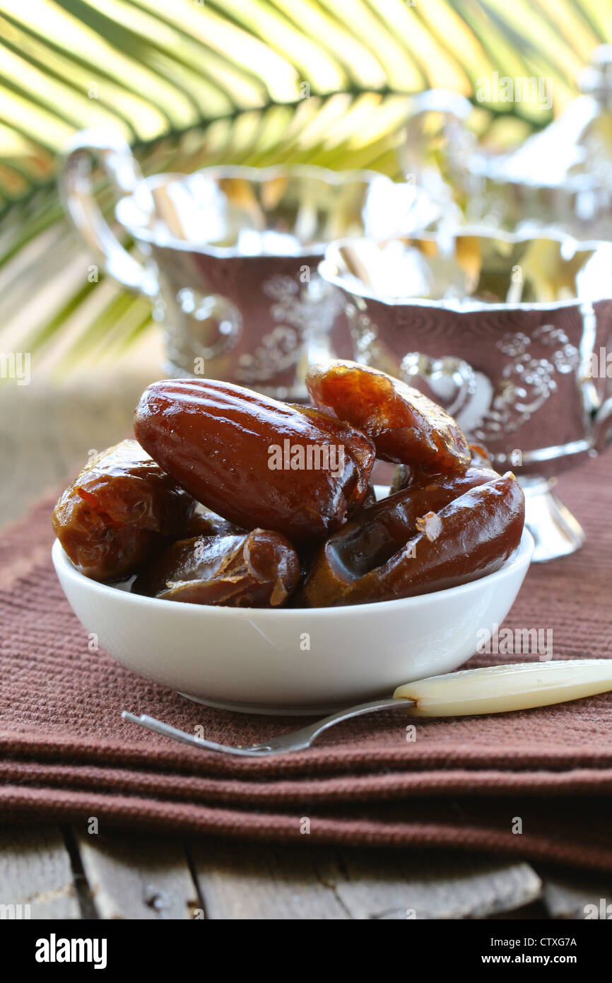 sweet dates in bowl on a natural background Stock Photo - Alamy