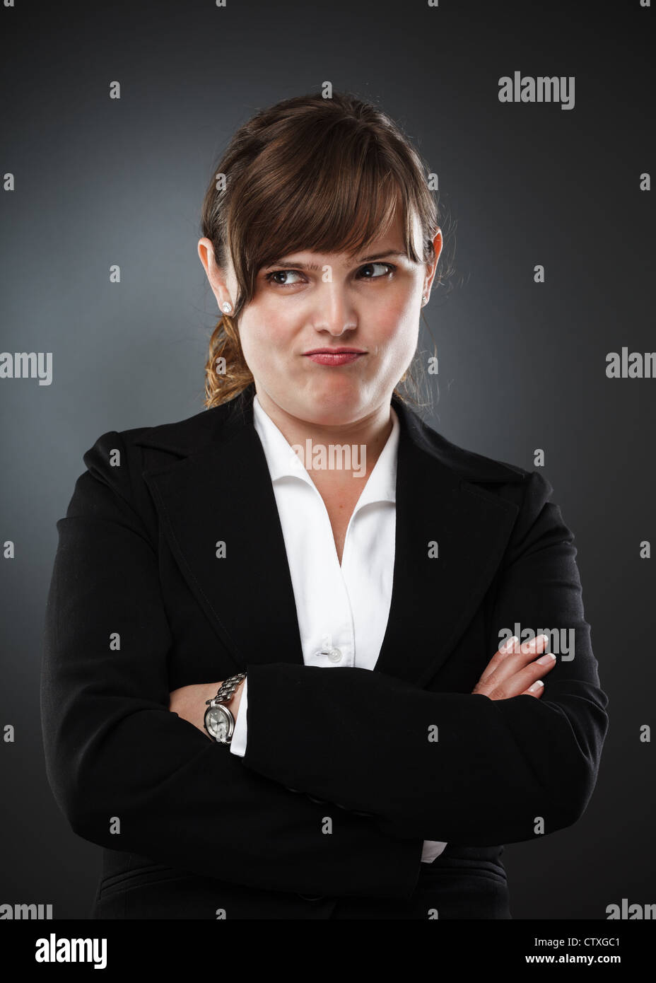 Businesswoman with an expression of distrust, studio shot Stock Photo ...