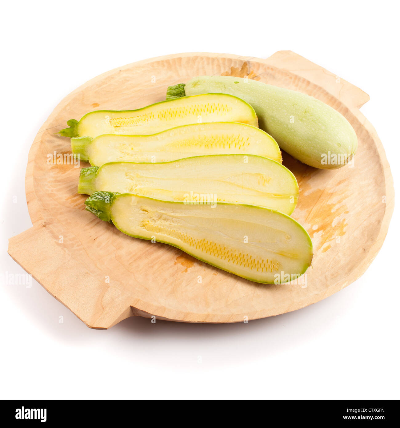 Closeup of sliced courgette on wooden board isolated on white ...