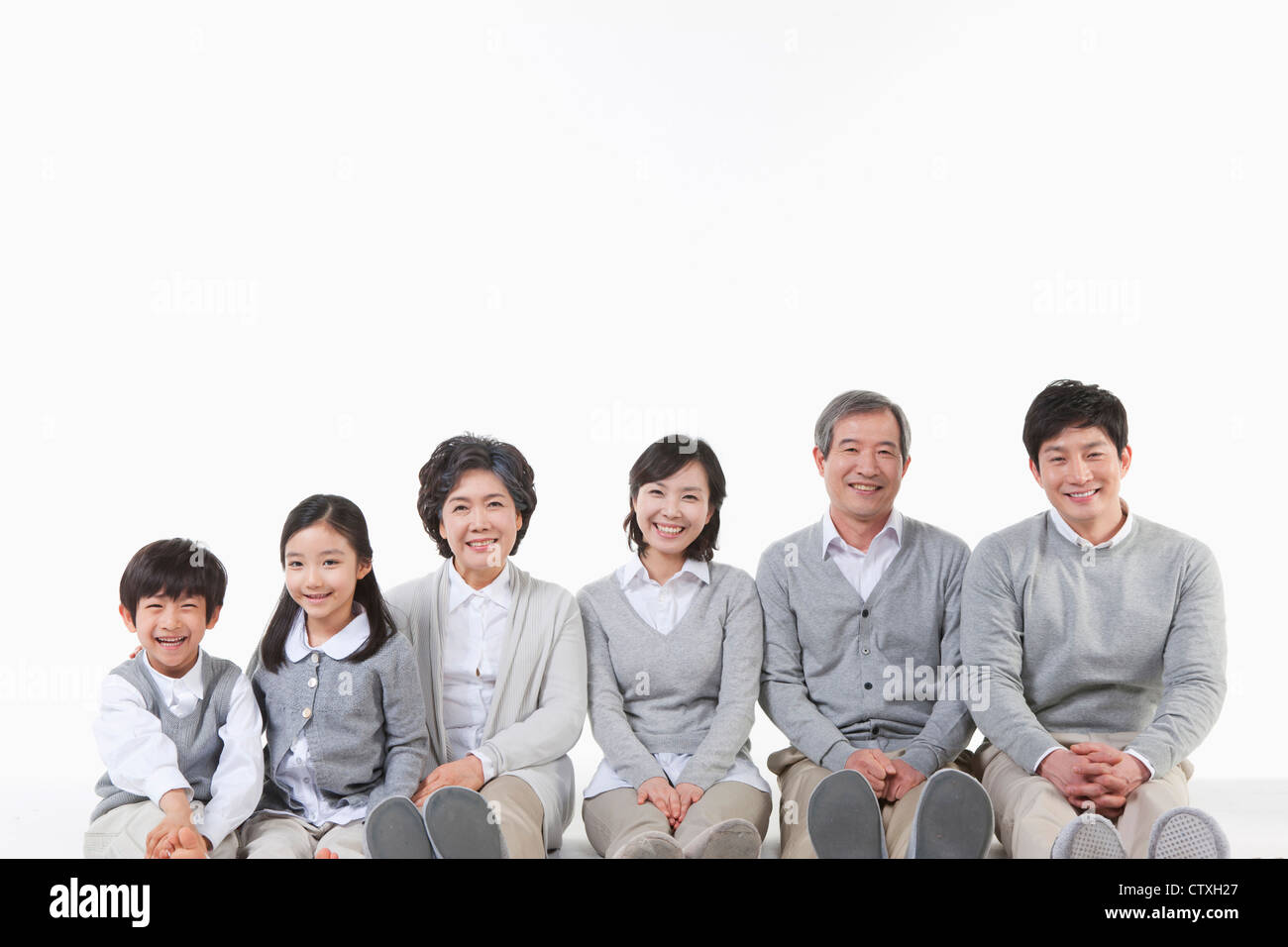 A large family sitting together Stock Photo - Alamy
