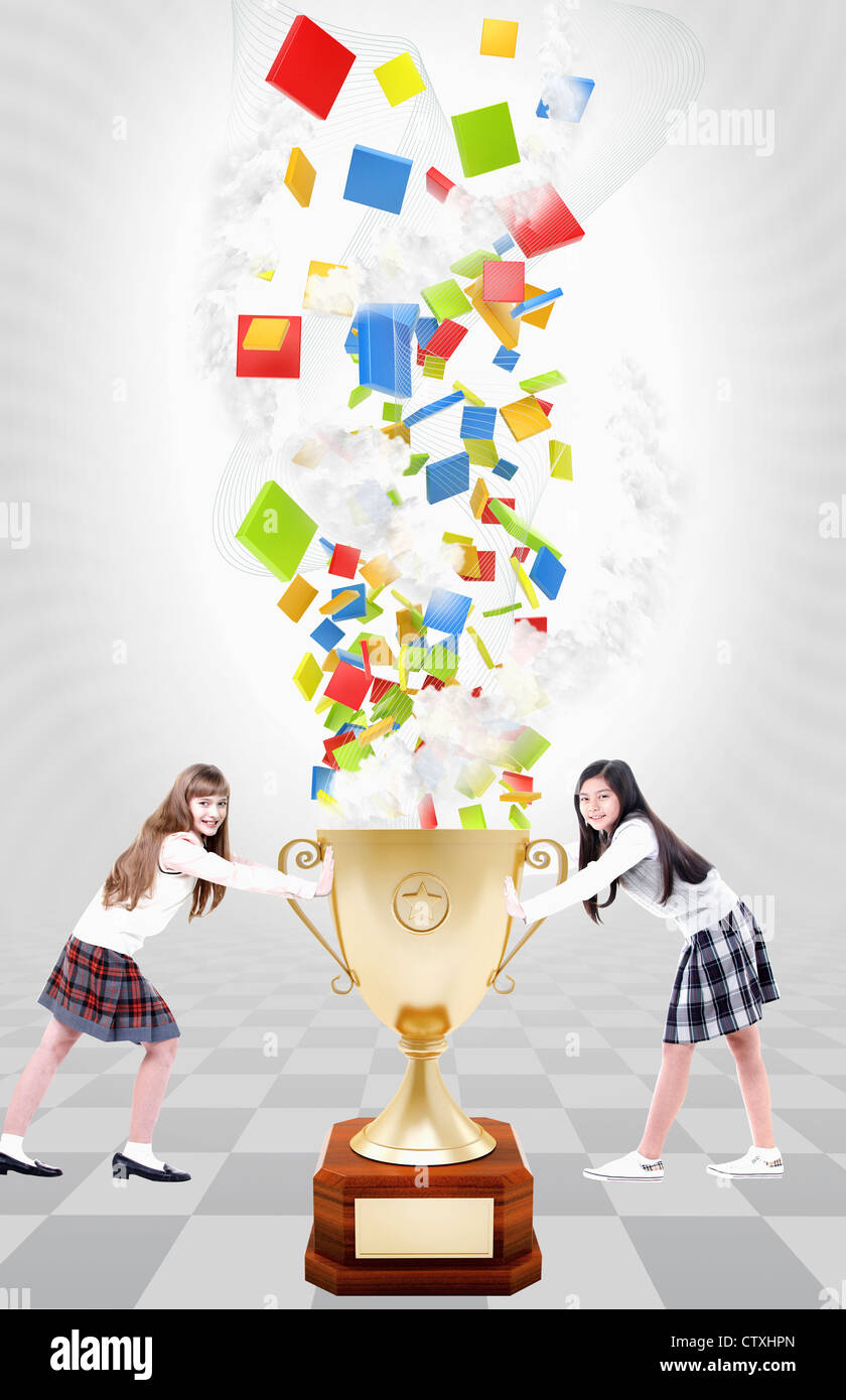 Global students pushing the book trophy Stock Photo - Alamy