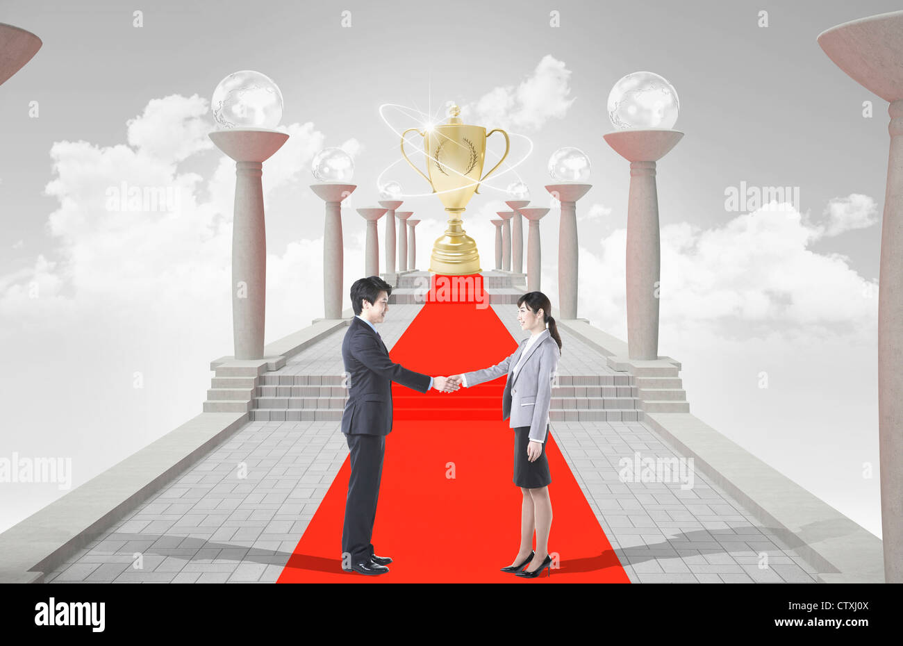 Businessmen shaking hands with golden trophy Stock Photo - Alamy