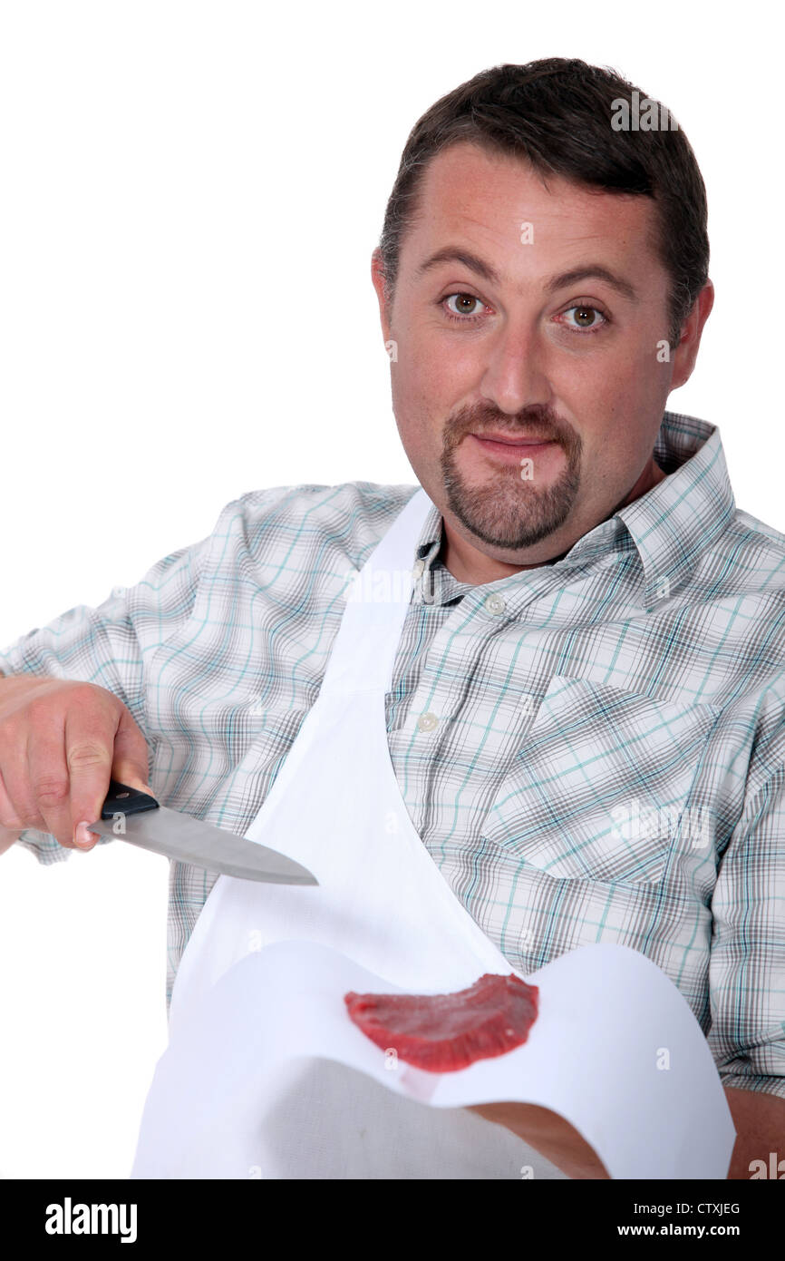 Butcher on white background with meat and knife Stock Photo - Alamy
