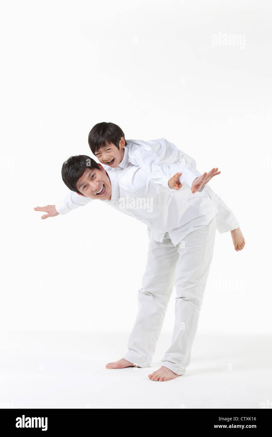 A father playing with his son on the back Stock Photo - Alamy