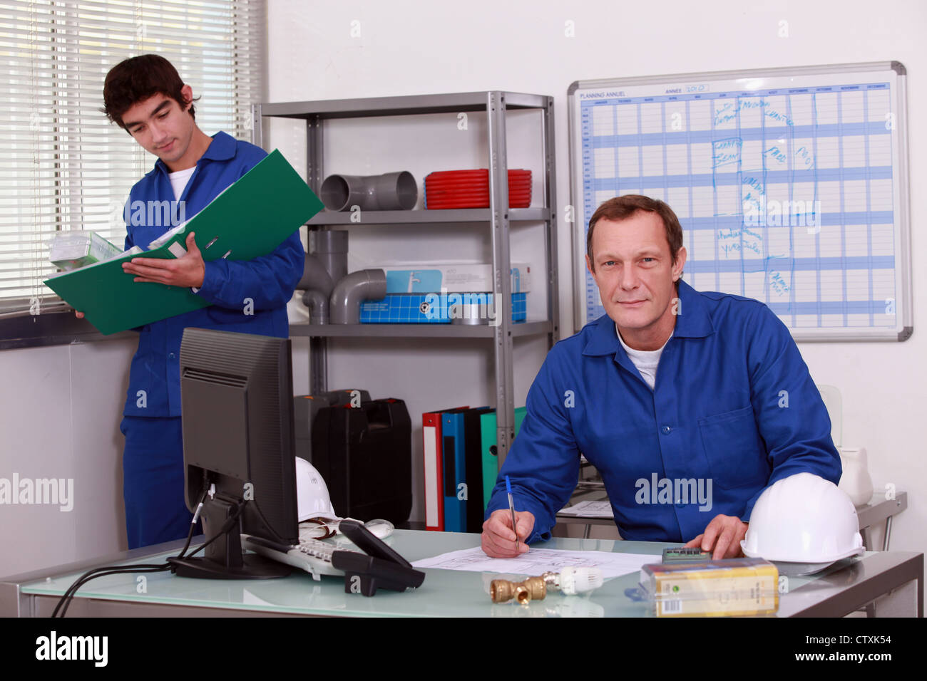 apprentice and trainer in workshop Stock Photo - Alamy