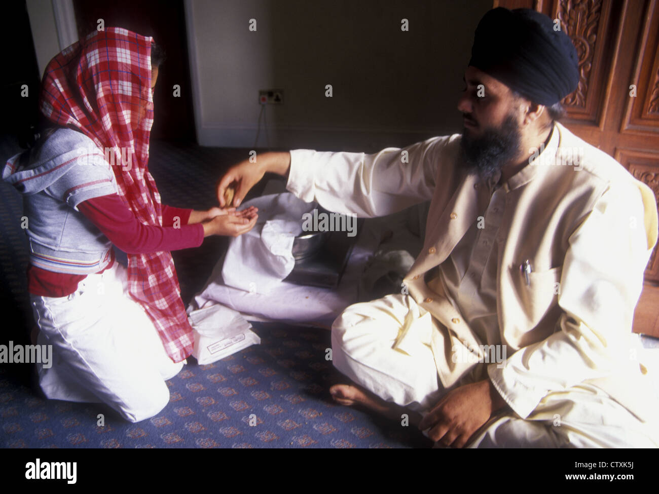 A woman receives holy parshad in a Sikh gurdwara Stock Photo - Alamy