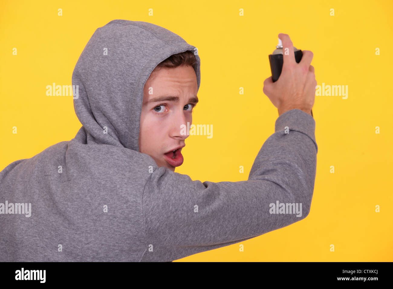 Young person spray painting wall Stock Photo - Alamy