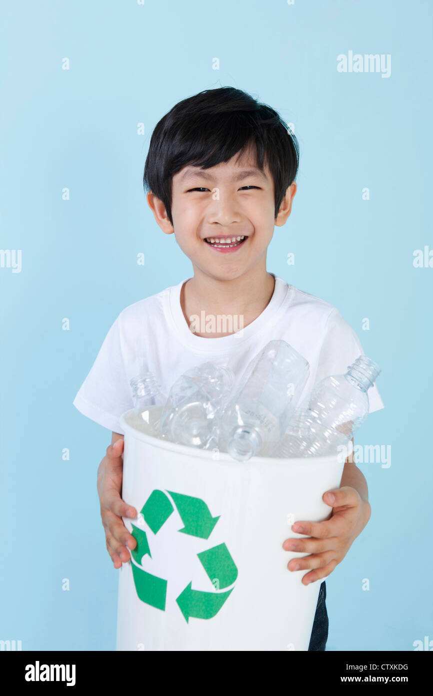 A boy smiling with recycling bin Stock Photo - Alamy