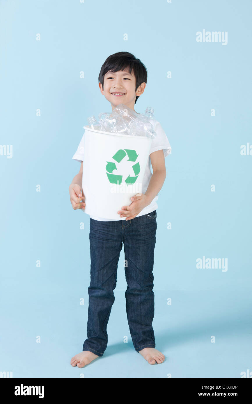 A boy smiling with recycling bin Stock Photo - Alamy