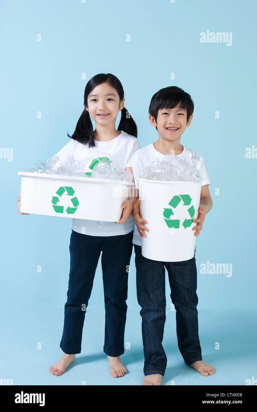 Children smiling with recycling bin Stock Photo - Alamy