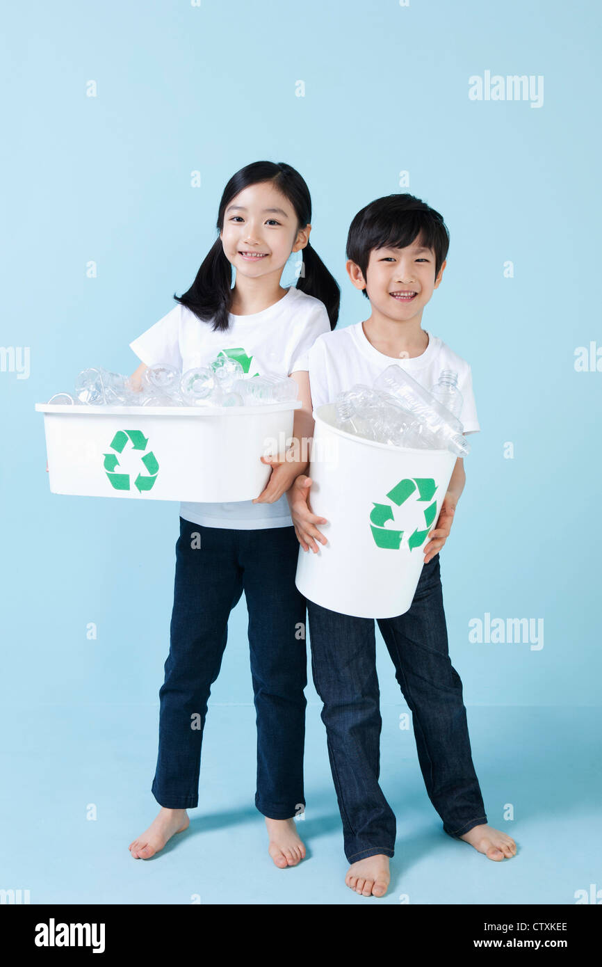 Children smiling with recycling bin Stock Photo - Alamy