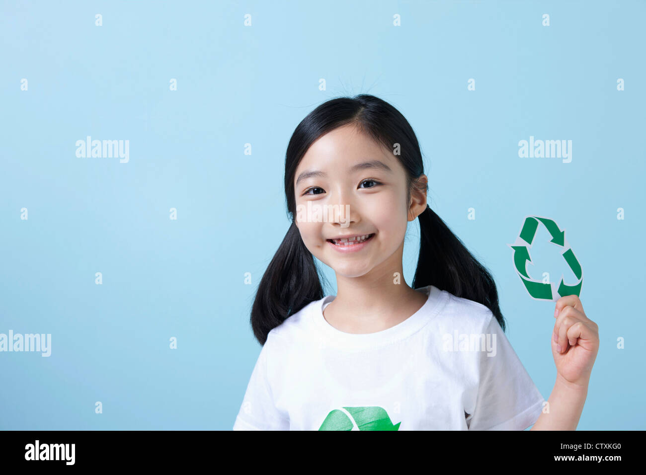A girl holding a recycling symbol Stock Photo - Alamy