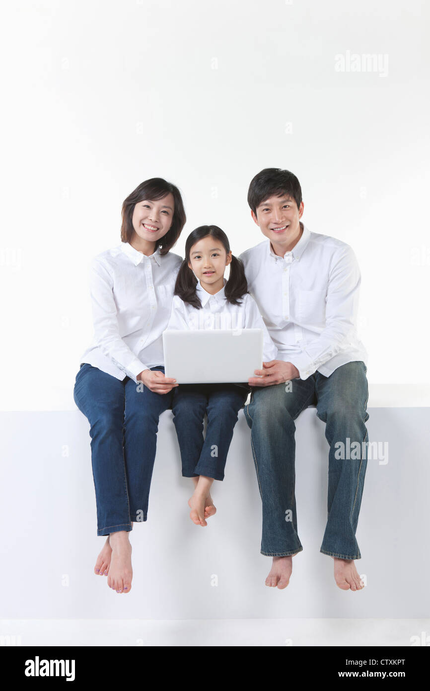 A happy family sitting with the laptop Stock Photo - Alamy