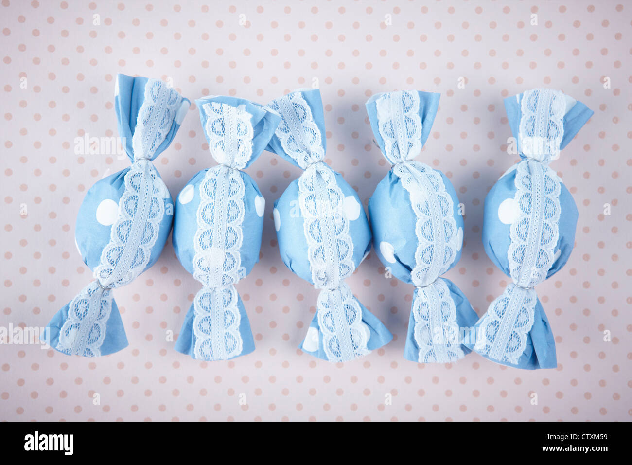 Candy in blue lace wrapping Stock Photo - Alamy