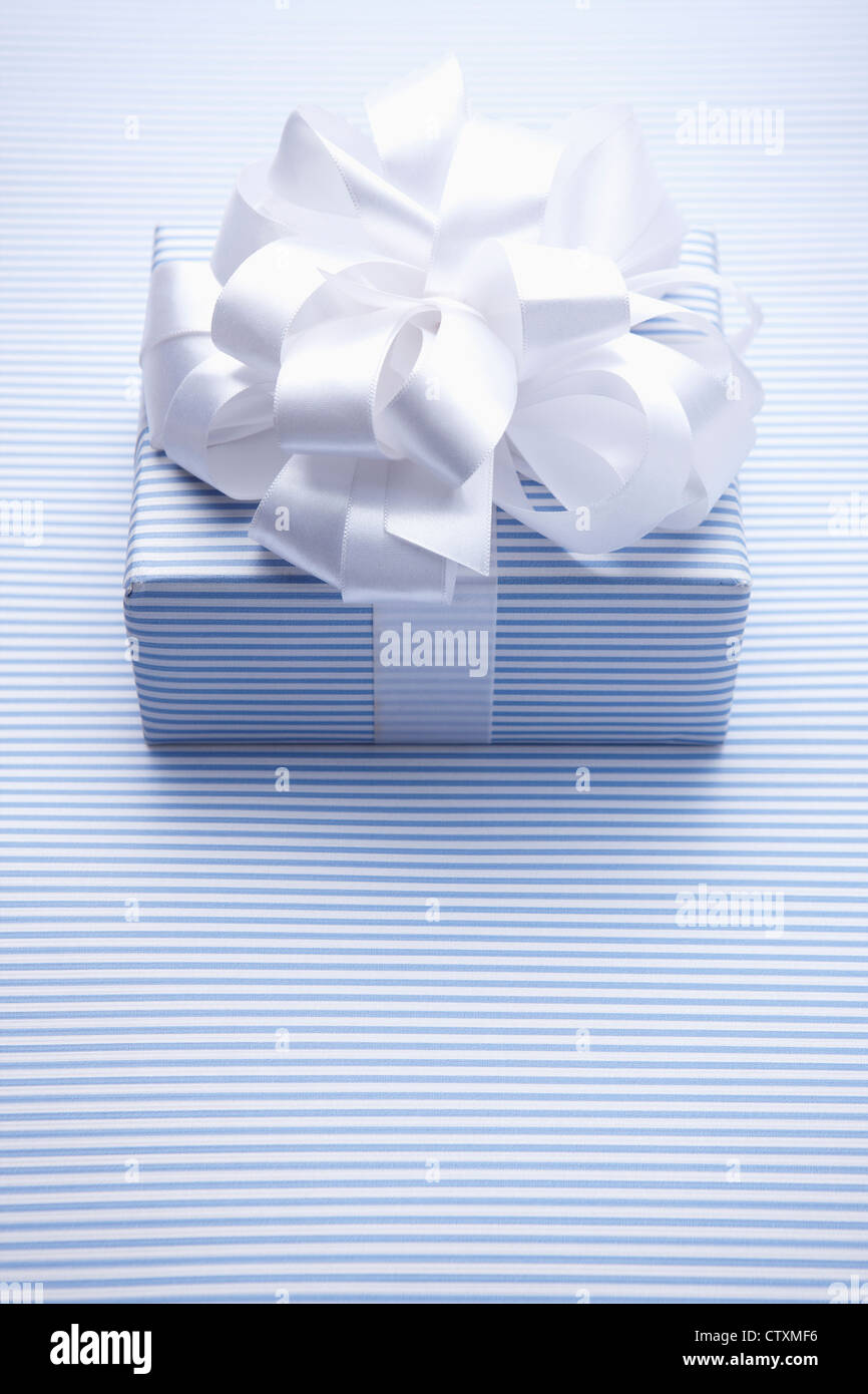 Blue stripe gift box with white ribbon Stock Photo - Alamy