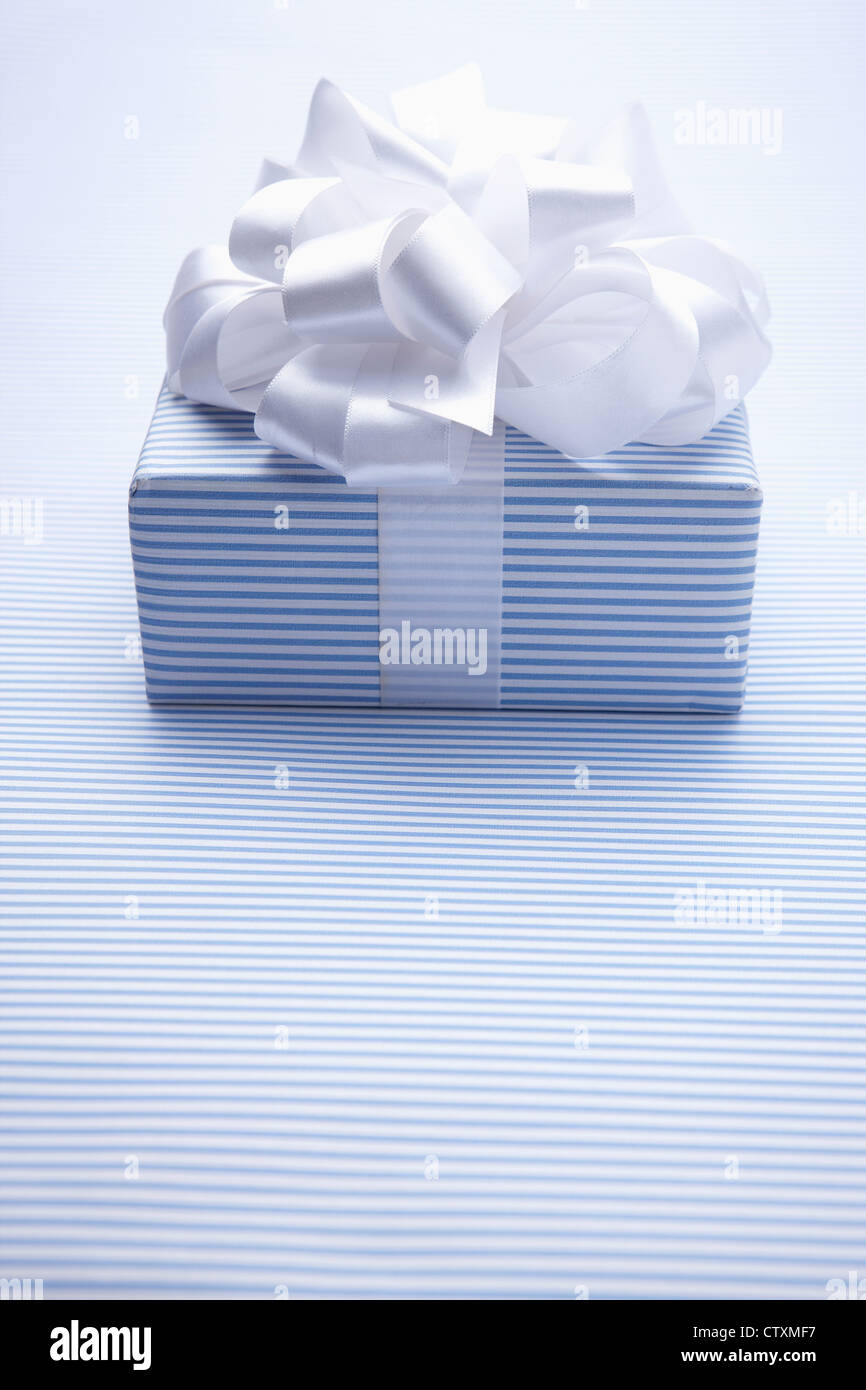 Blue stripe gift box with white ribbon Stock Photo - Alamy