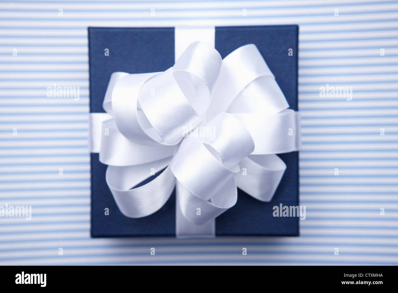 Blue gift box with white ribbon Stock Photo - Alamy