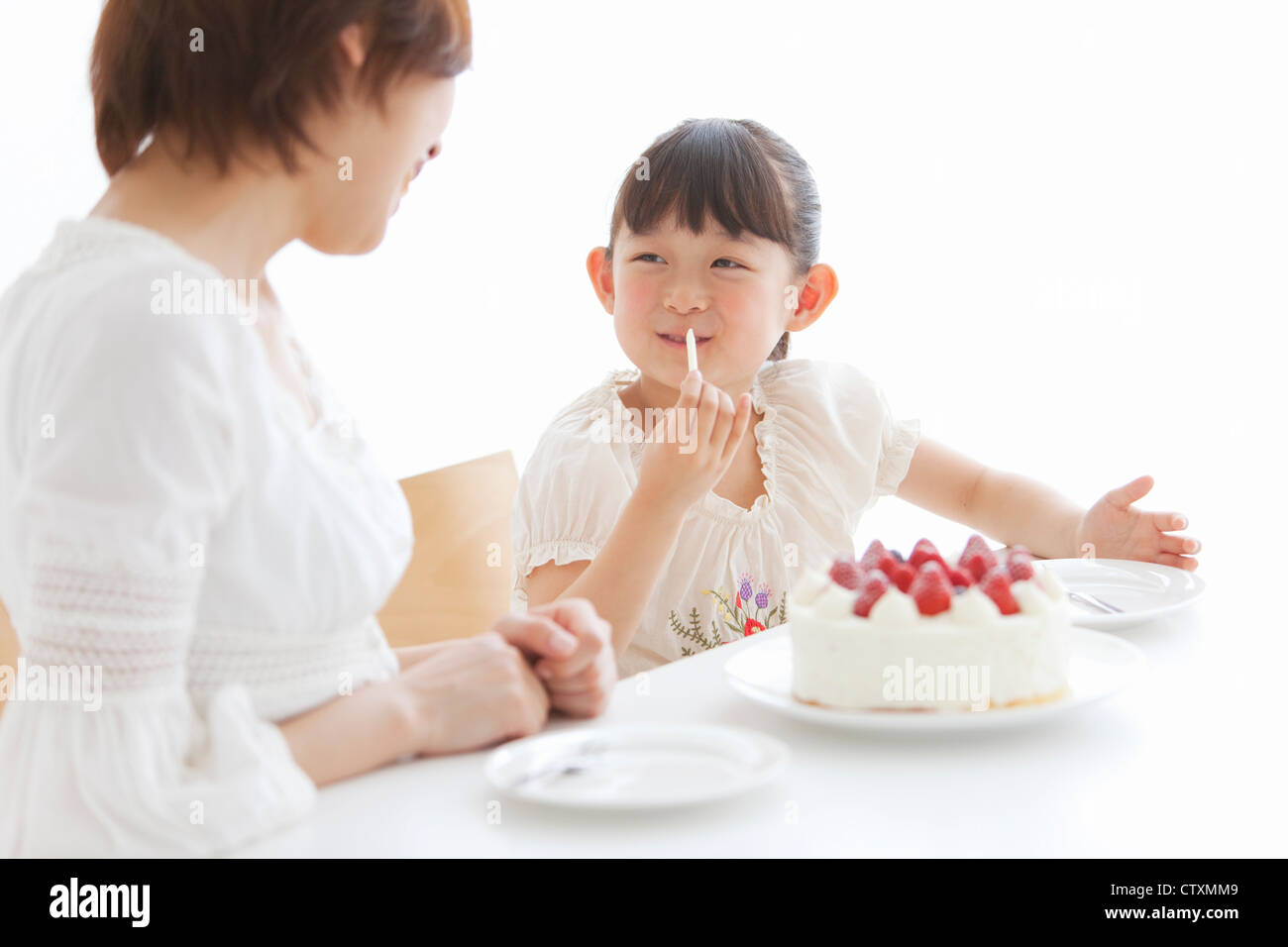 Mother and daughter eating cake Stock Photo - Alamy