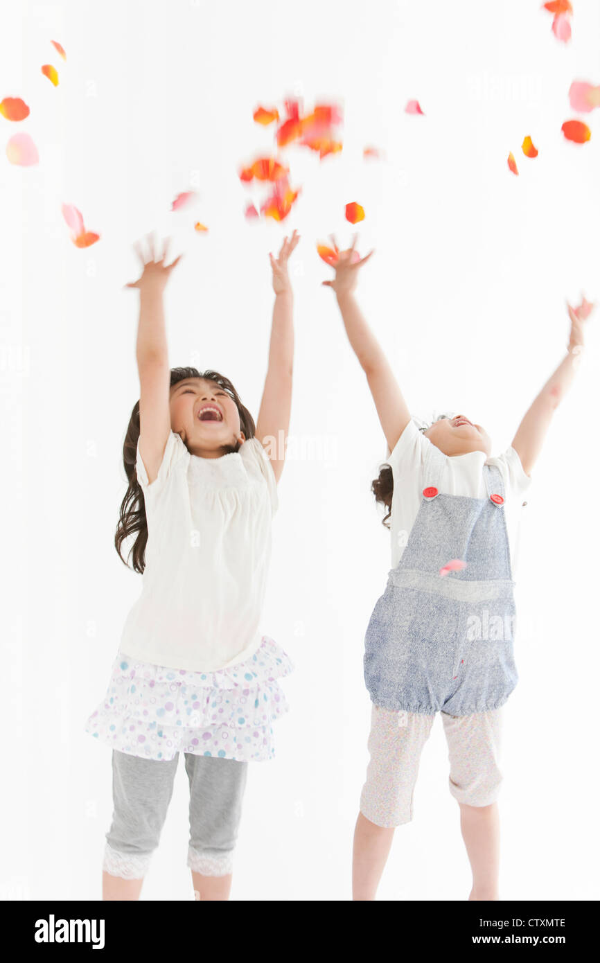 Two Girls Playing With Flower Petals Stock Photo - Alamy