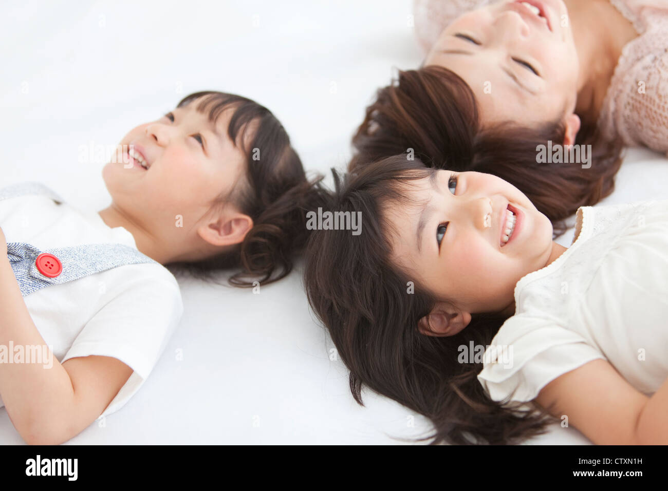 Family With Two Children, Laying On Back Stock Photo - Alamy