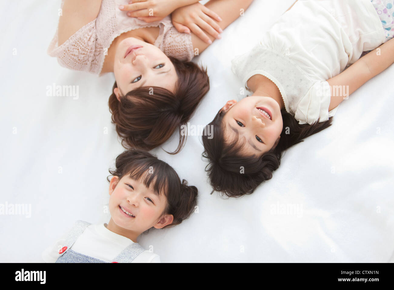 Family With Two Children, Laying On Back Stock Photo - Alamy