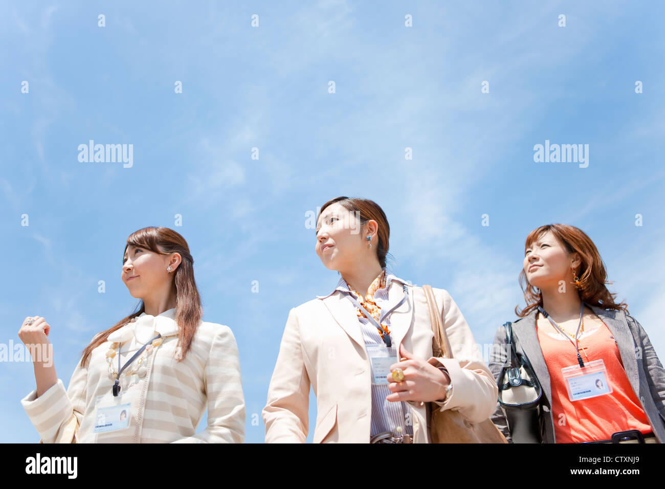 Three Business Women, Looking Into The Far Distance Stock Photo - Alamy
