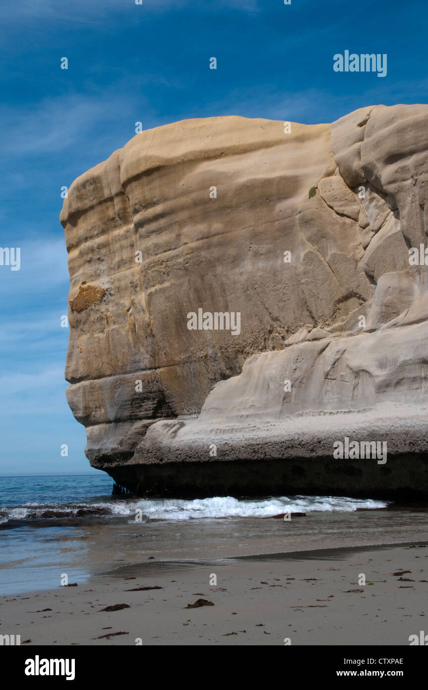 Sea-carved sandstone clilffs, rock arches and caves form Tunnel Beach ...