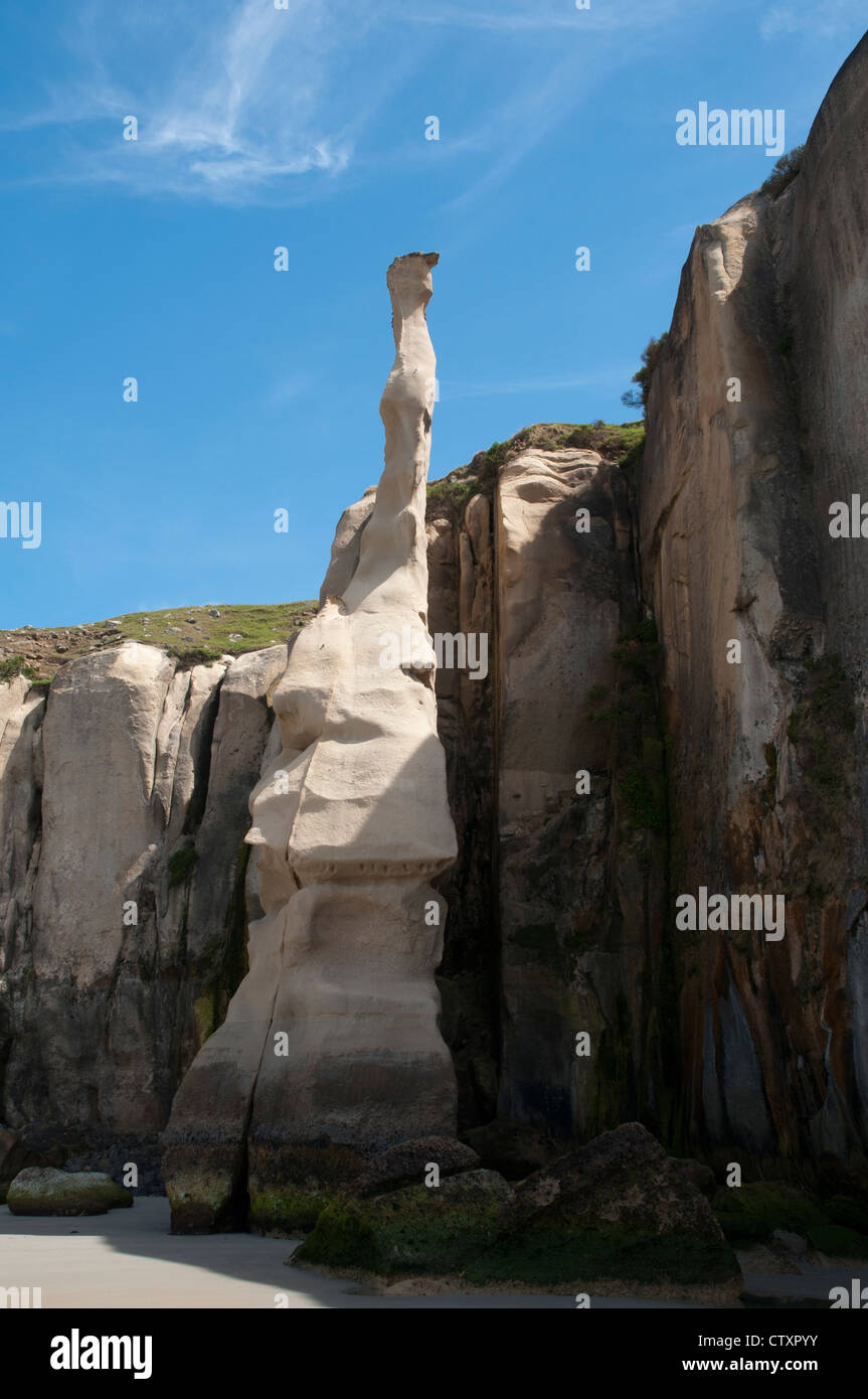 Sea-carved sandstone clilffs, rock arches and caves form Tunnel Beach ...
