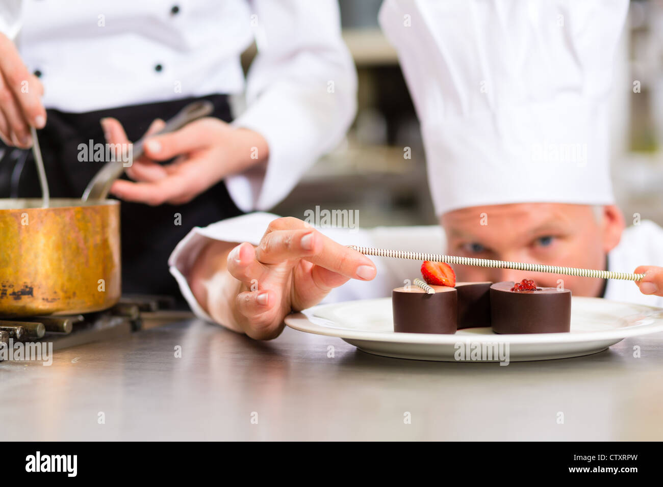 Cook, the pastry chef, in hotel or restaurant kitchen cooking, he is ...