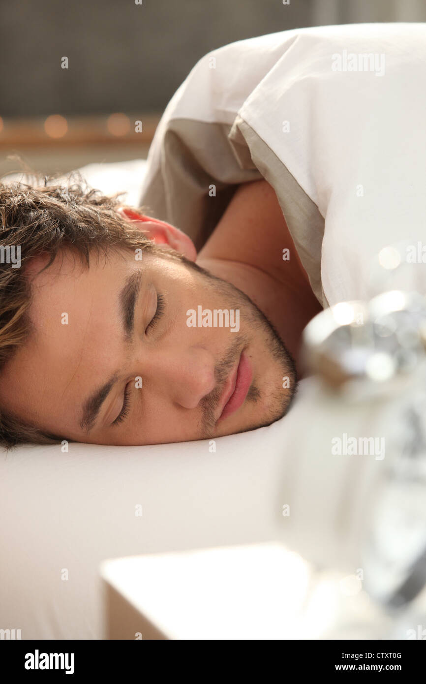 Man asleep in bed Stock Photo - Alamy