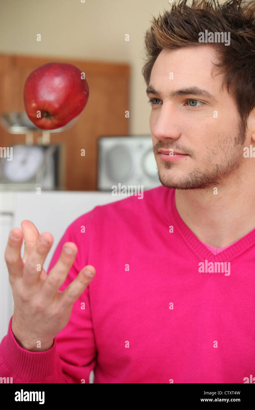 Man catching apple Stock Photo - Alamy