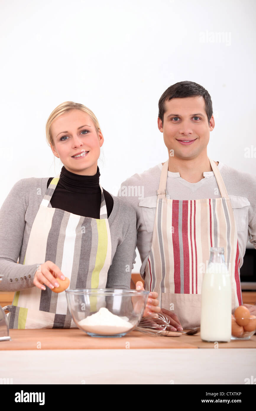 Couple baking in the kitchen Stock Photo - Alamy