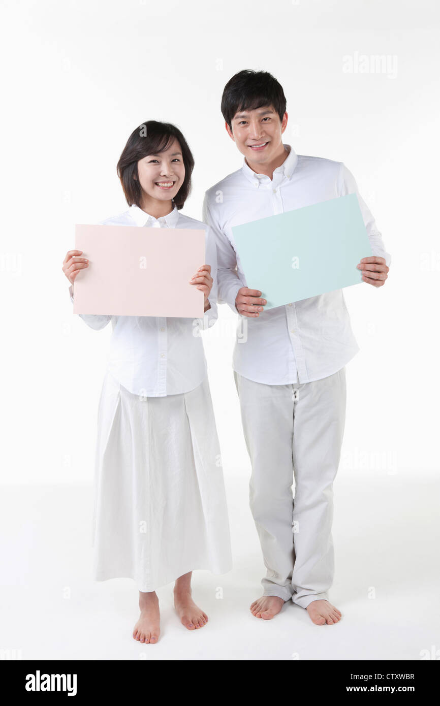 A couple with blue and pink board Stock Photo - Alamy