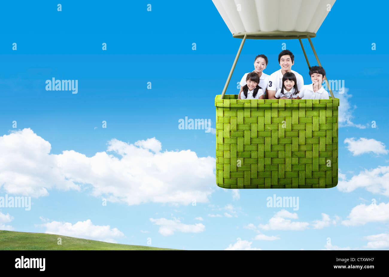 A happy family on the green hot-air balloon Stock Photo - Alamy