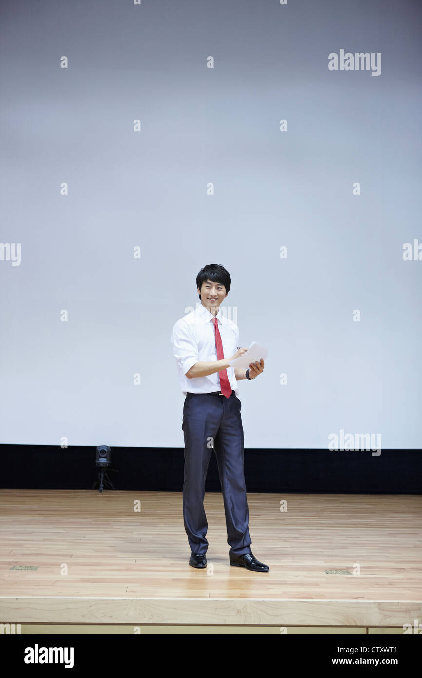 A businessman having presentation on the stage Stock Photo - Alamy