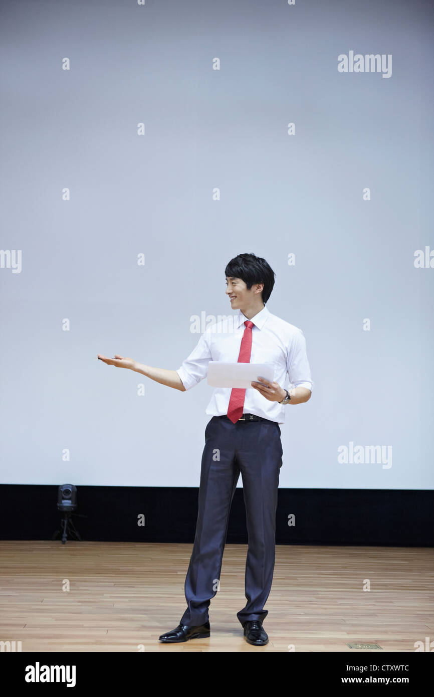 A businessman having presentation on the stage Stock Photo - Alamy